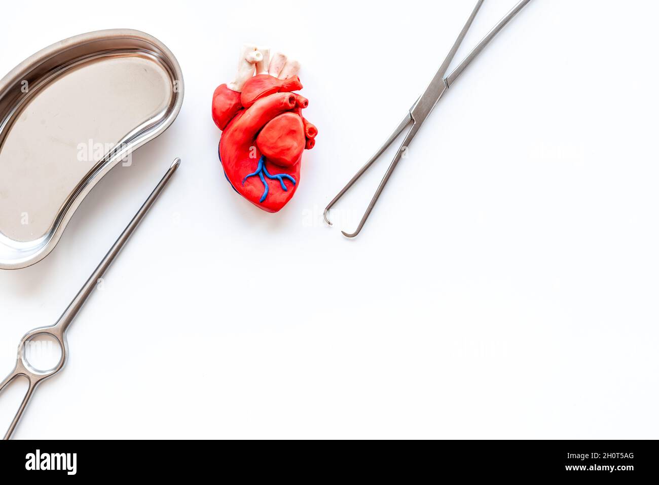 Surgical instruments and heart model. Heart surgery concept Stock Photo ...