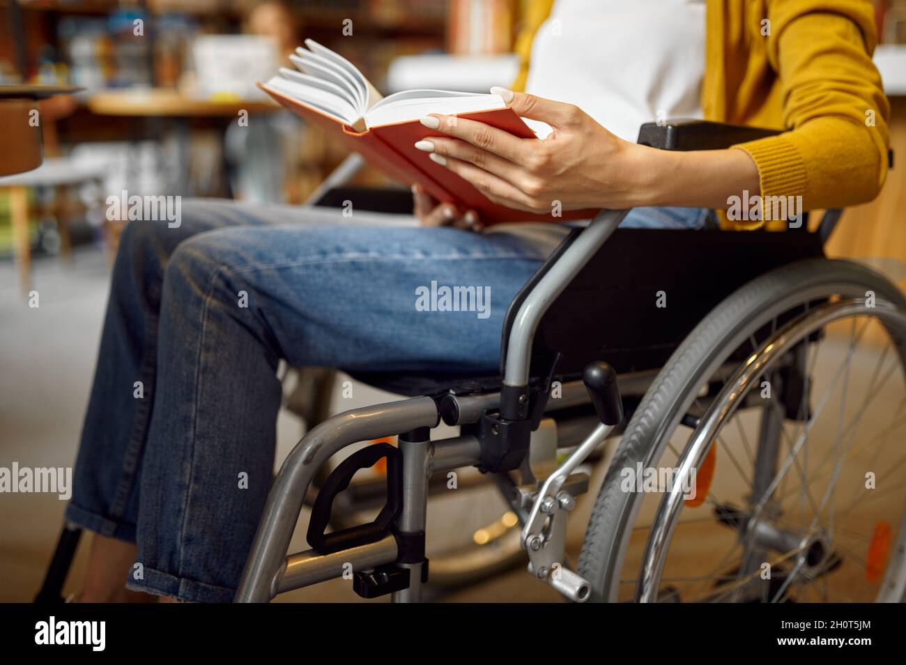 Disabled student in wheelchair reading a book Stock Photo - Alamy