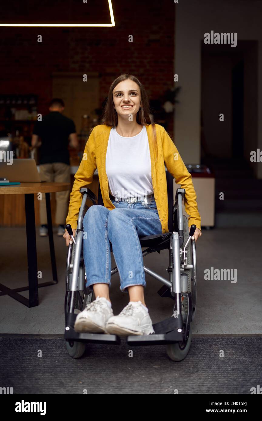 Disabled female student in wheelchair at window Stock Photo - Alamy