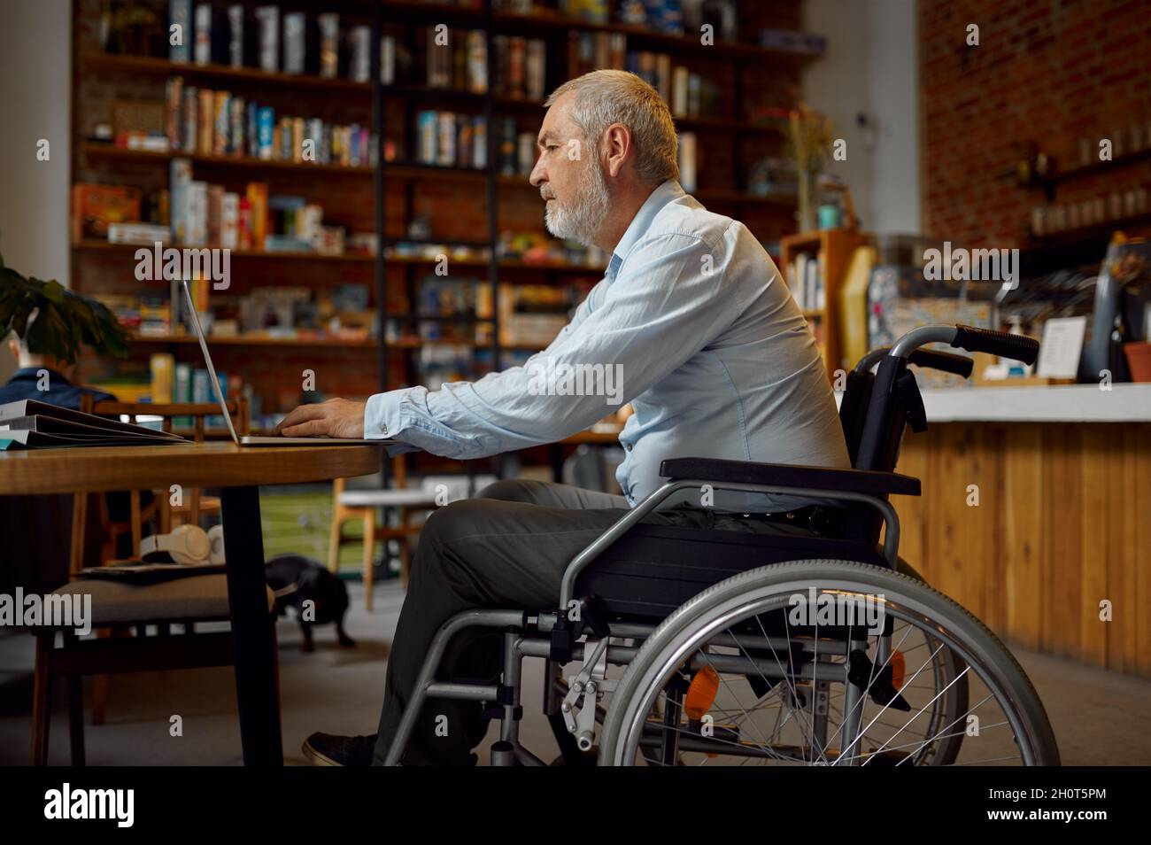Adult disabled man using laptop, top view Stock Photo - Alamy