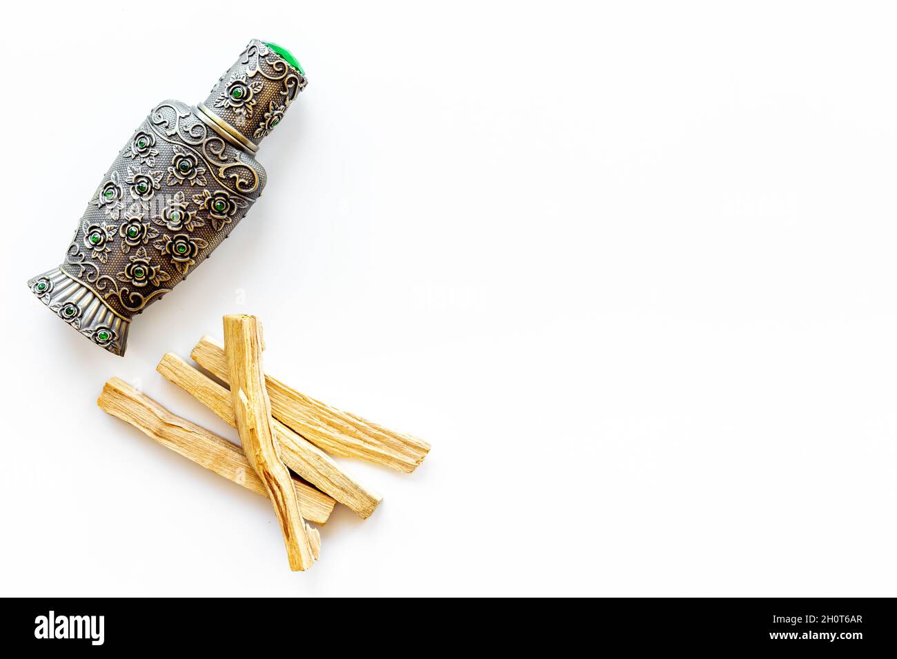 Arabic oud oil perfume in silver bottle with crystals and sticks of ...