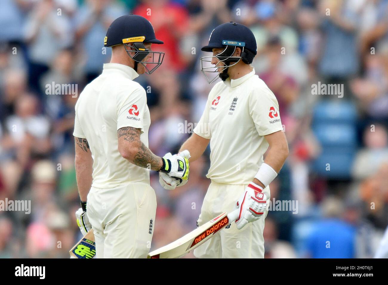 England's Ben Stokes congratulates Joe Root (right) after Root scored ...