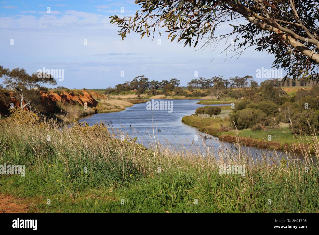 Natural view of a calm river flowing downstream in the countryside ...