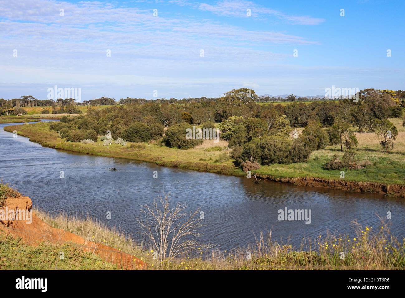 Natural view of a calm river flowing downstream in the countryside ...