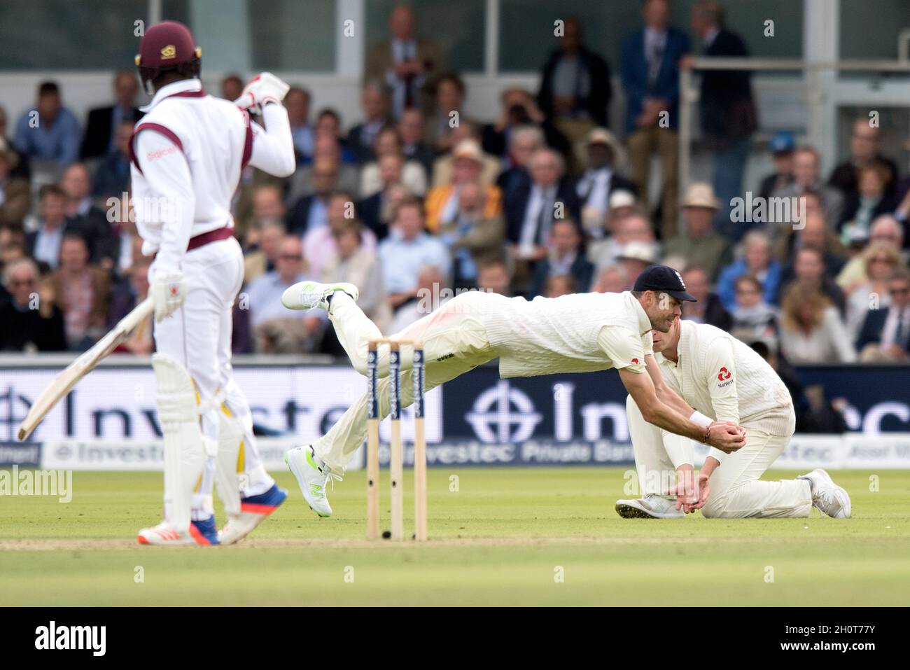 England's James Anderson dives to take the catch of West Indies' Kemar ...