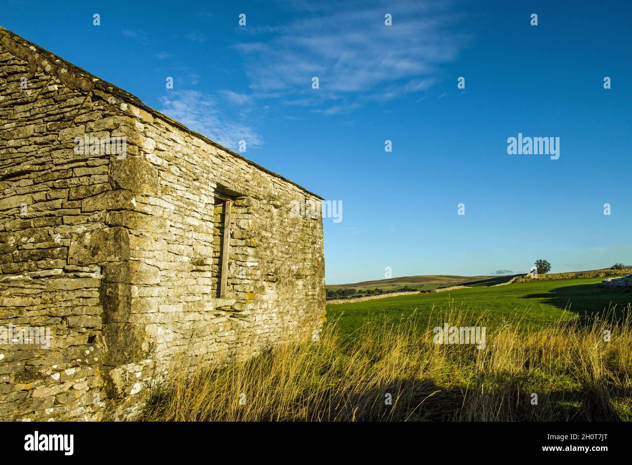 An old derelict limestone barn at the top of Ravenstonedale in Cumbria ...