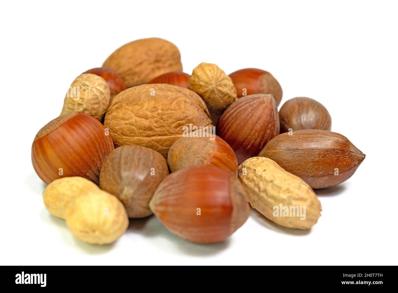 Various nuts against a white background Stock Photo - Alamy