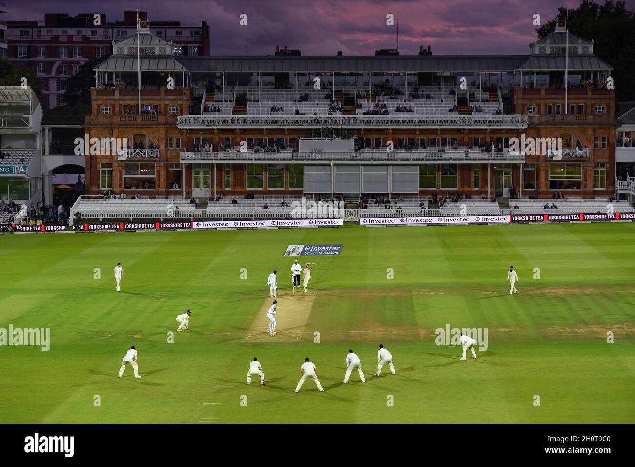 England's Stuart Broad bowls the final over as the sun sets behind the ...