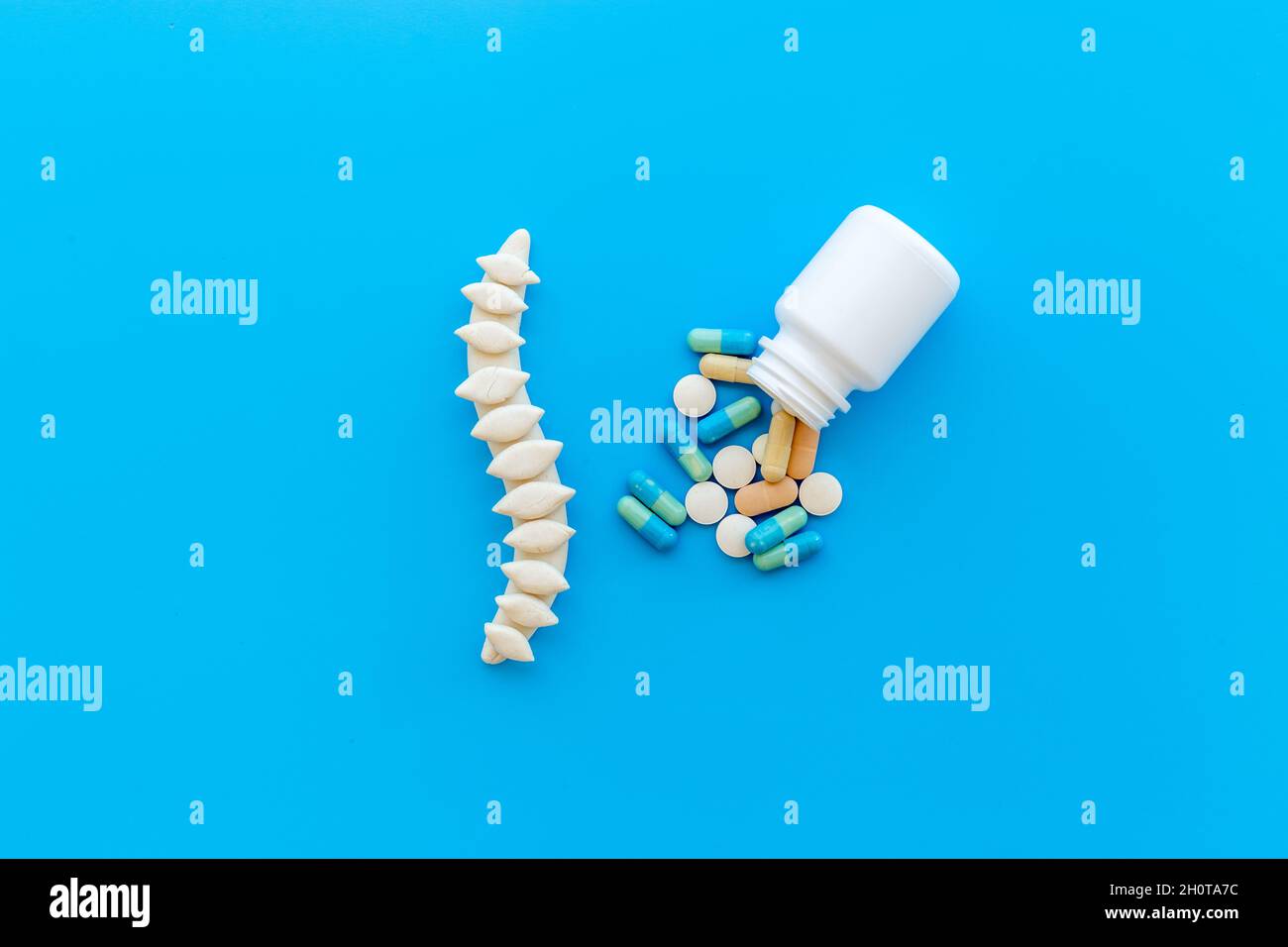 Anatomical spine skeleton with medical pills. Spinal diseases treatment ...