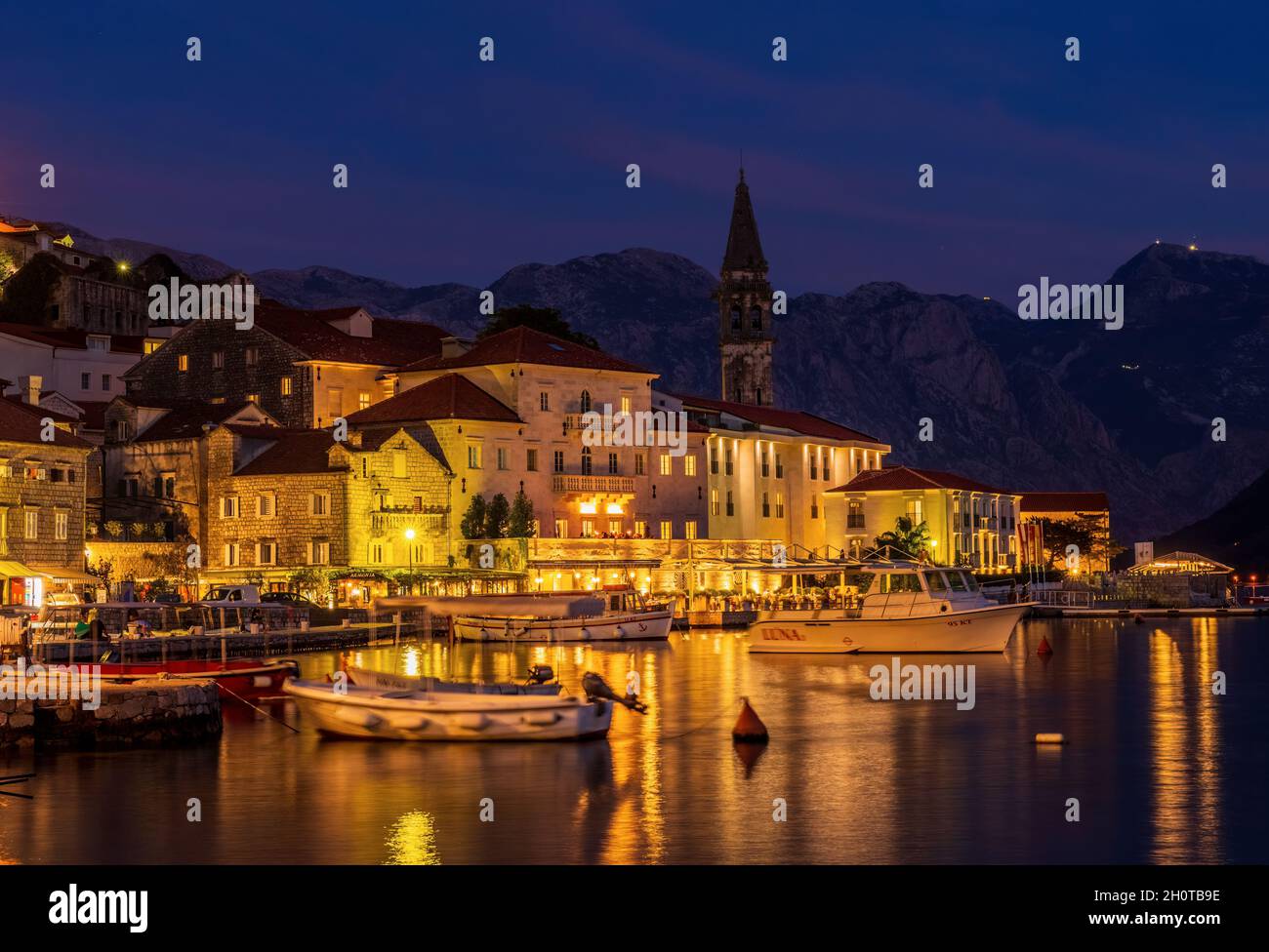 Sunset at the waterfront of the old town Perast in the Bay of Kotor in ...