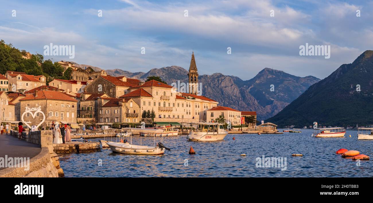 Sunset at the waterfront of the old town Perast in the Bay of Kotor in ...