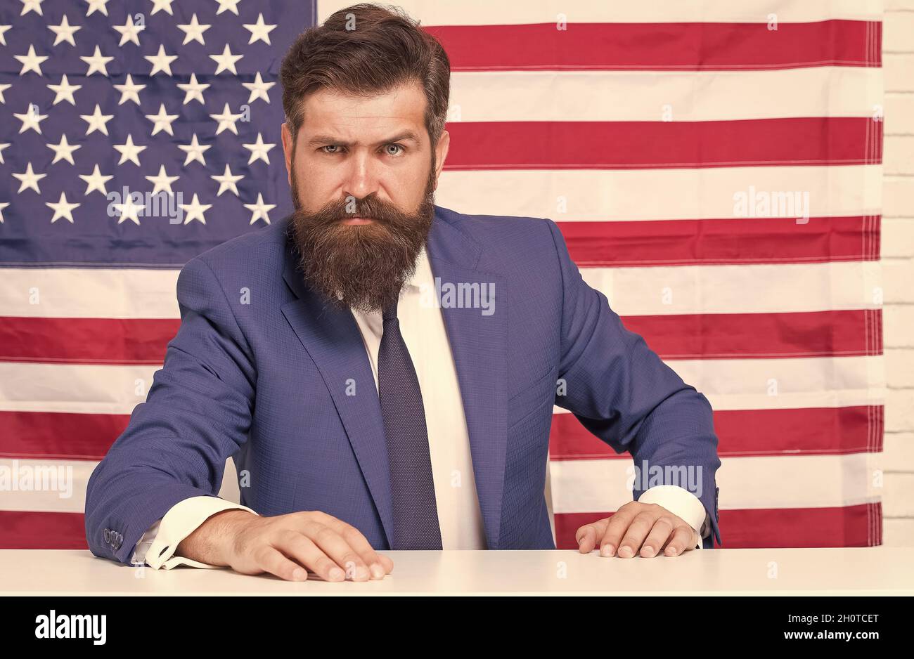 Patriotic education. Patriotic man sit on USA flag background. American ...