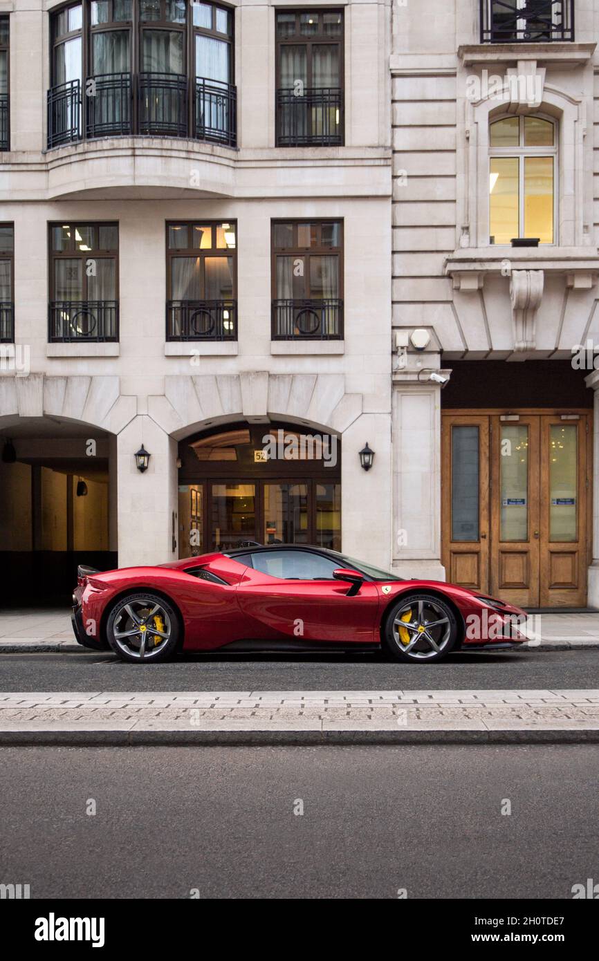 Red Ferrari SF90 Stradale supercar parked on a street in Mayfair area ...