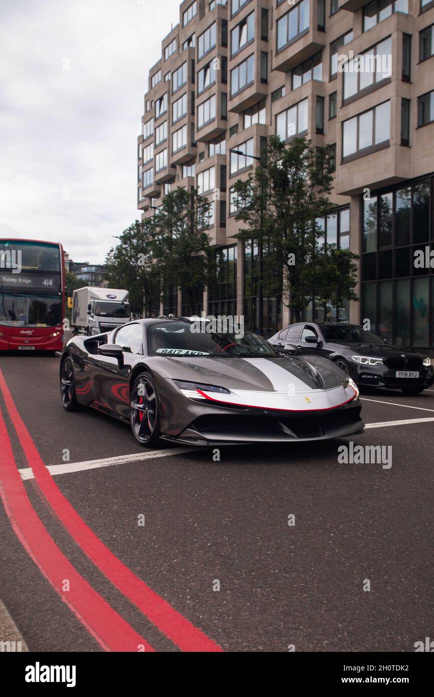 Silver with white and red details Ferrari SF90 Stradale supercar driven ...