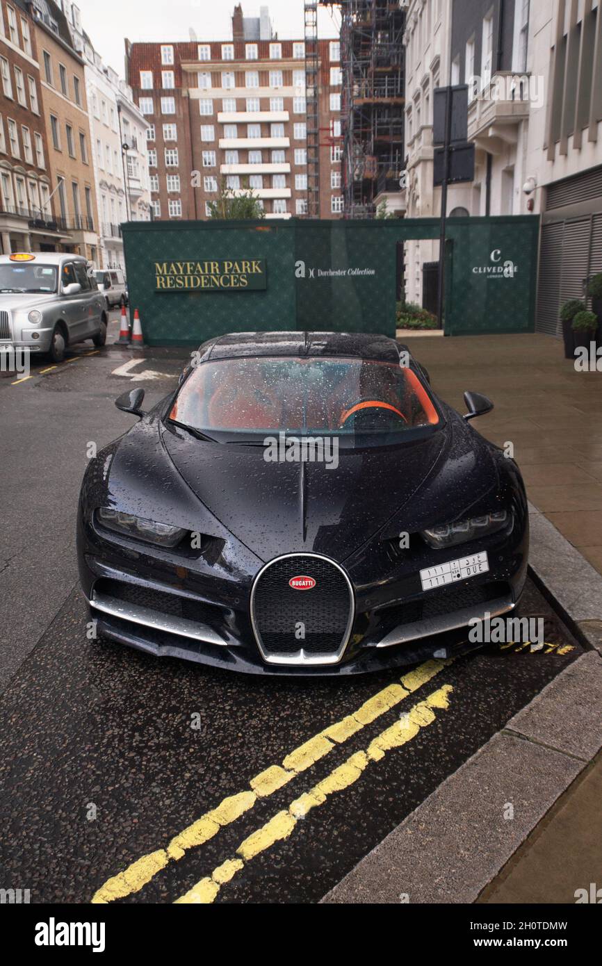 Black Bugatti Chiron supercar with orange interior parked at a luxury ...