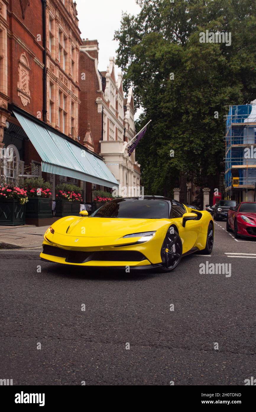 Yellow Ferrari SF90 Stradale supercar driven on a street in Mayfair ...