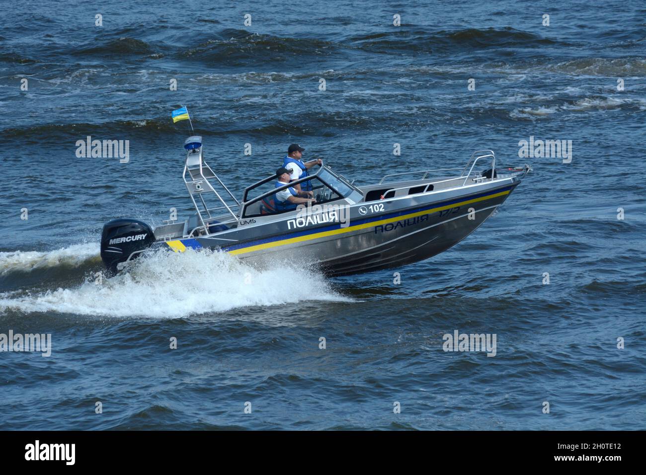 Police boat with officers aboard floating on water Stock Photo - Alamy