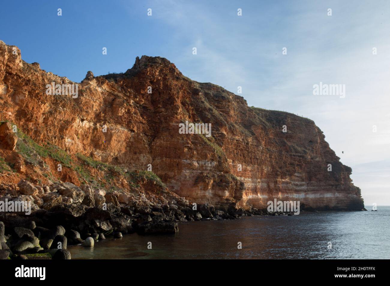 Scenic view of a high cliff and an ocean on a clear sky background ...