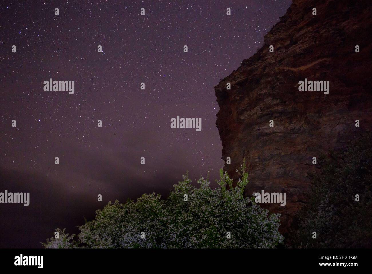 Scenic view of a rocky cliff on a night sky background Stock Photo - Alamy