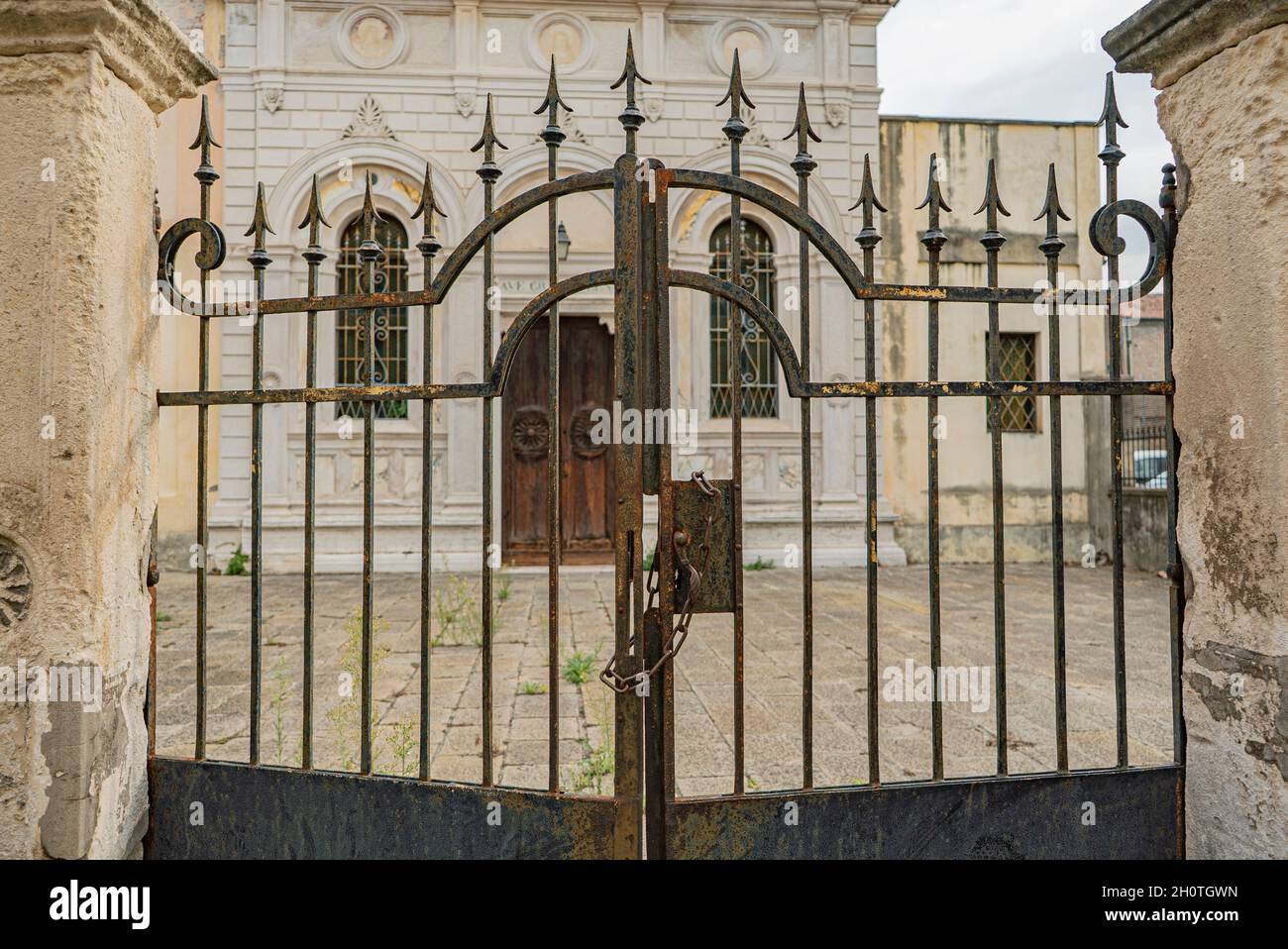 Wrought iron gate spikes detail in an ancient building in Italy Stock ...