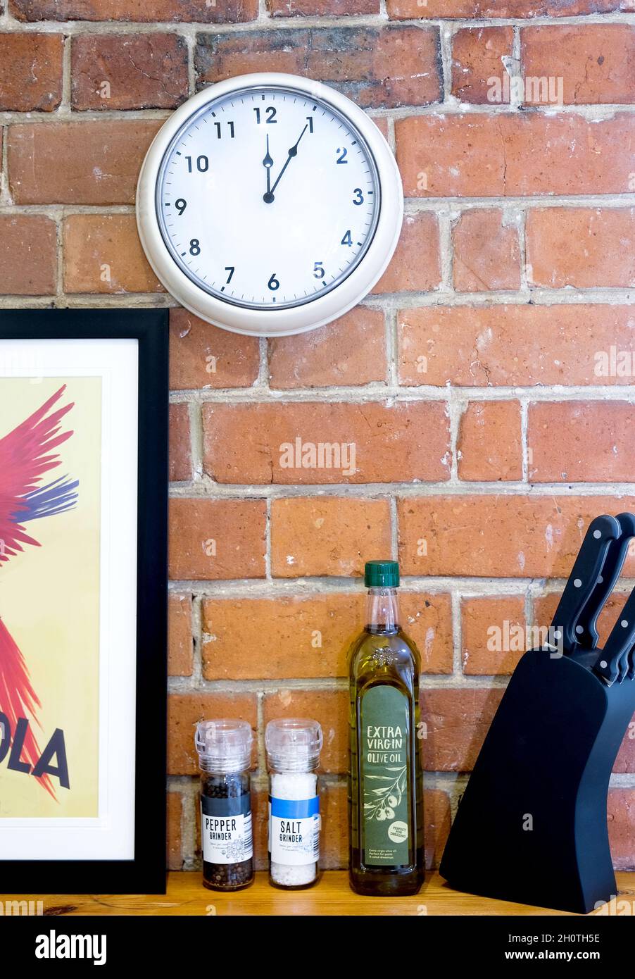 detail of area of kitchen wall with white kitchen clock shelf with salt ...