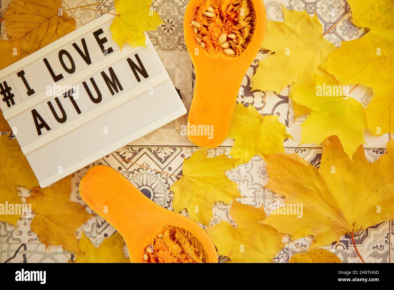 Aesthetic autumn decorations and food on ceramic tile background. Text ...