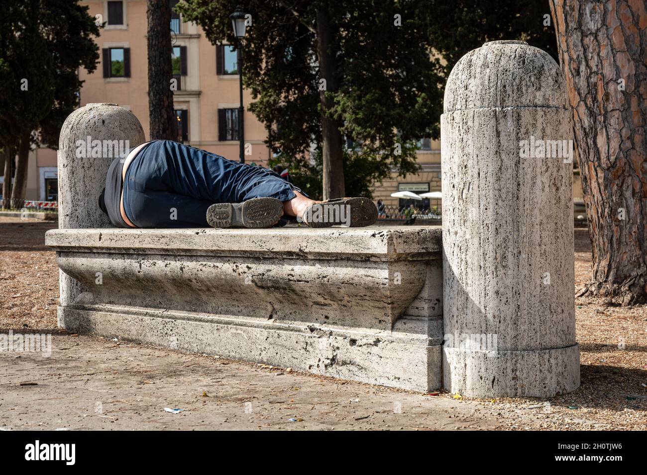 Homeless person sleeping on park bench in Rome, Italy Stock Photo - Alamy
