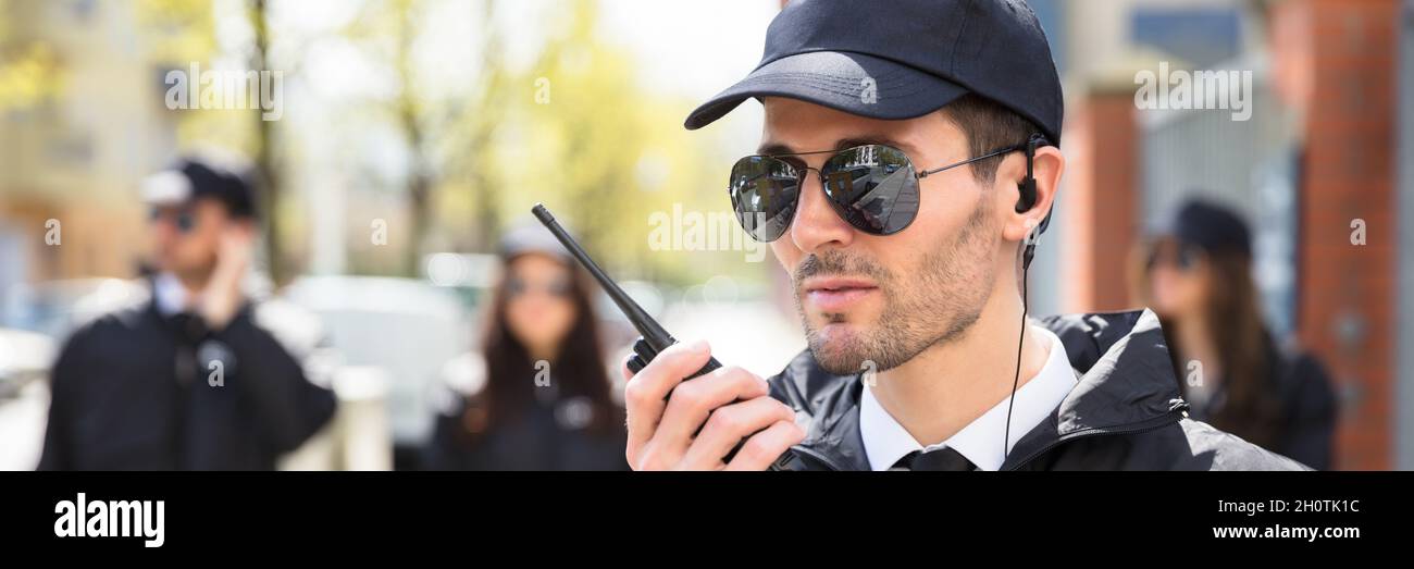 Security Guard Event Service. Officer And His Group Stock Photo - Alamy Security Guard Event Service. Officer And His Group Stock Photo - Alamy