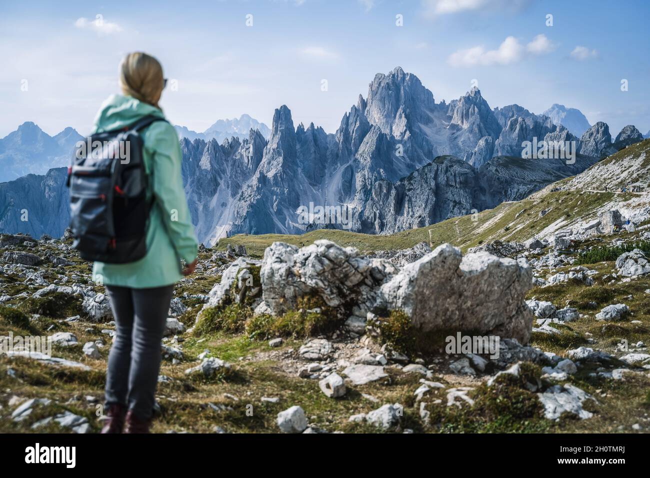 Woman hiker with backpack against Cadini di Misurina mountain group ...