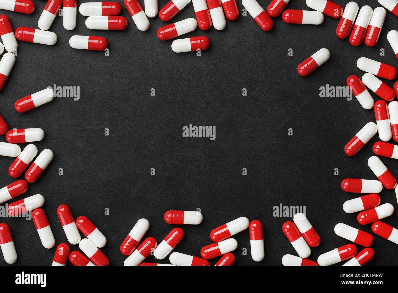 Red and white tablets in the form of a frame with free space on a black ...