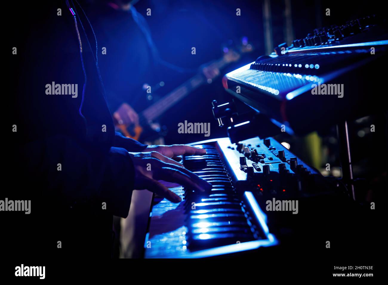 Artist playing on the keyboard synthesizer piano keys during the live ...
