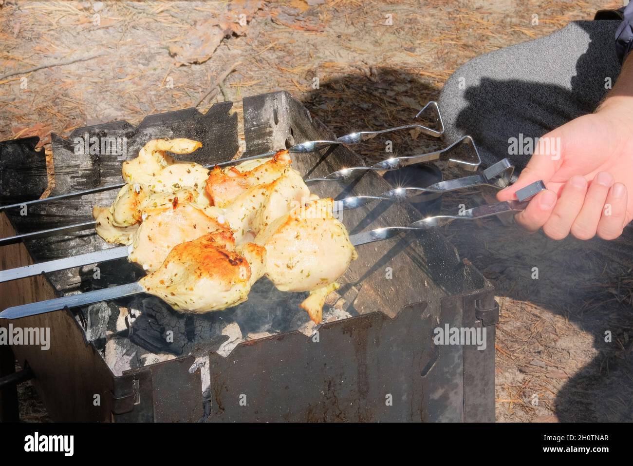 Shish kebab frying on grillin open air. Chicken meat is fried on ...