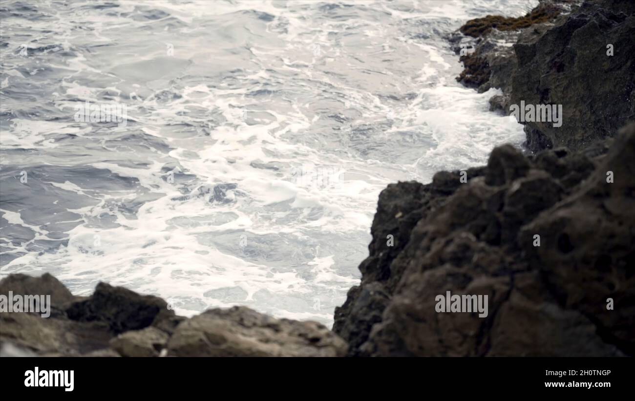 The waves fighting about the rocky ocean coast. Action. View of the ...