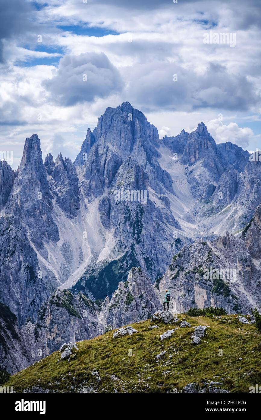 Woman hiker with backpack against Cadini di Misurina mountain group ...