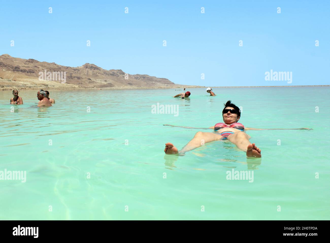 EIN BOKEK, ISRAEL - MAY 10, 2011: Unidentified woman is resting on the surface of the Dead Sea ...