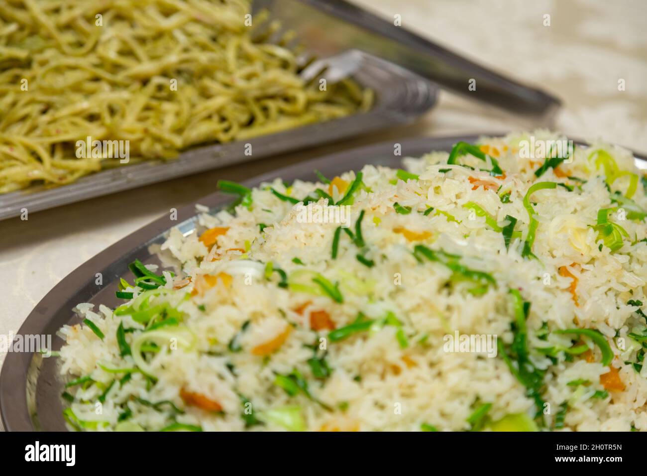 Plates with rice and pasta on a buffet table for a birthday party Stock ...