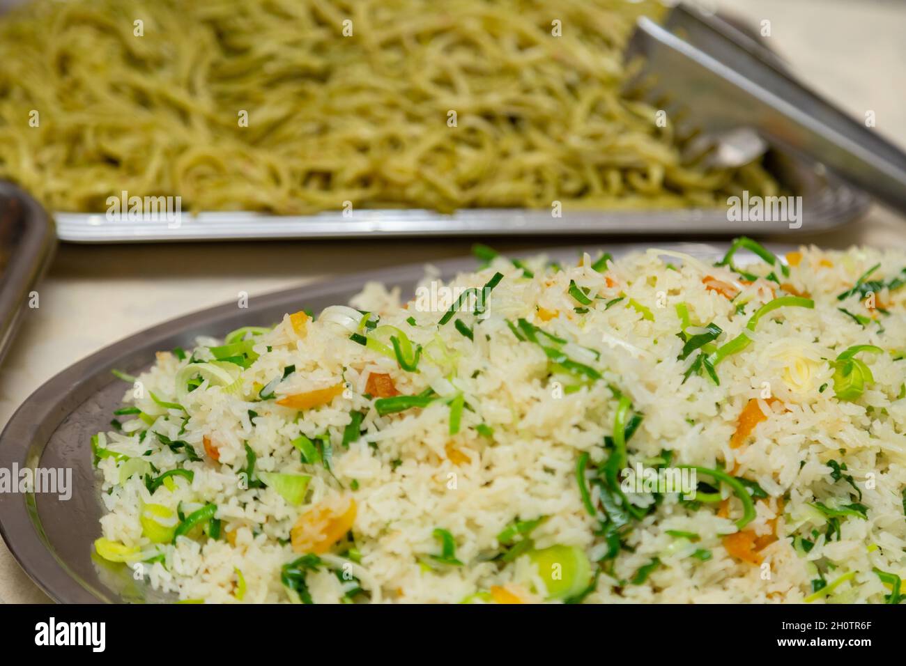 Plates with rice and pasta on a buffet table for a birthday party Stock ...