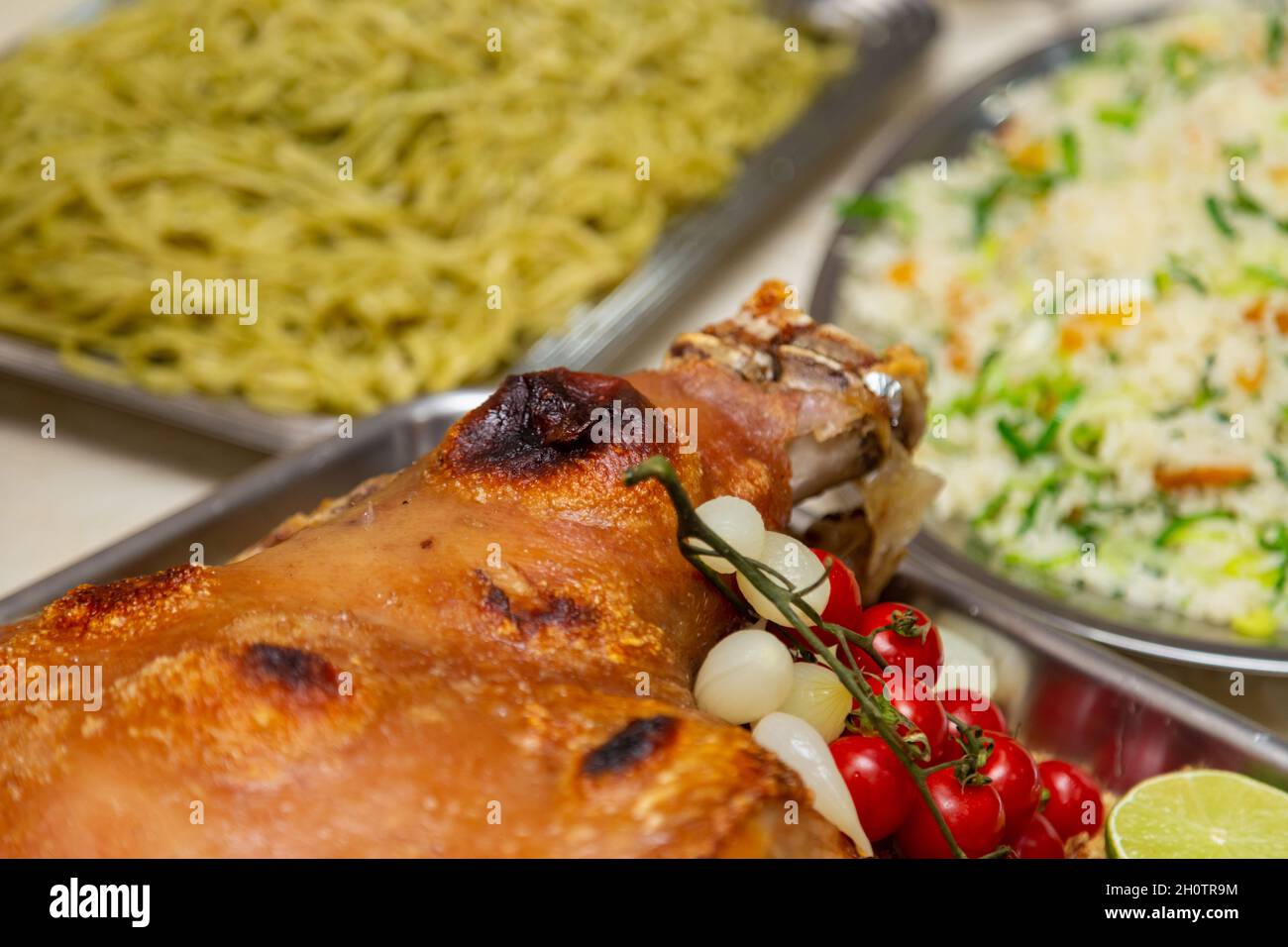 Detail of oven-roasted meat, rice and pasta dishes, on a buffet table ...