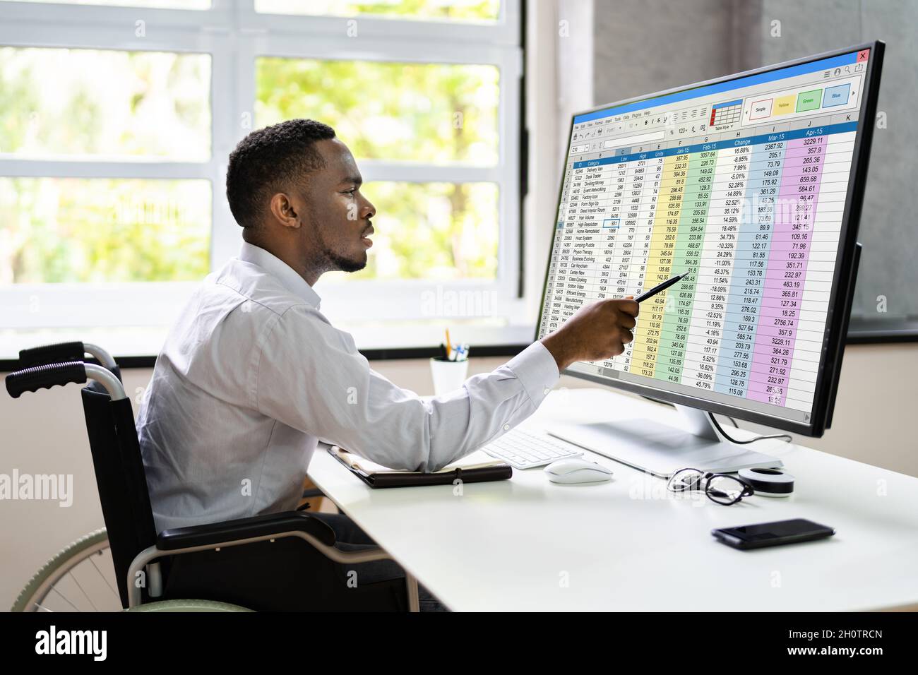 Medical Coding Spreadsheet On PC. African Man In Wheelchair Stock Photo ...