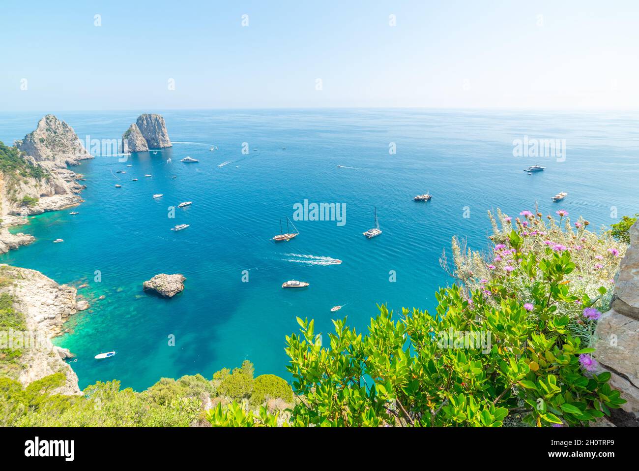 Boats by world famous Capri sea stacks on a clear day. Campania, Italy ...