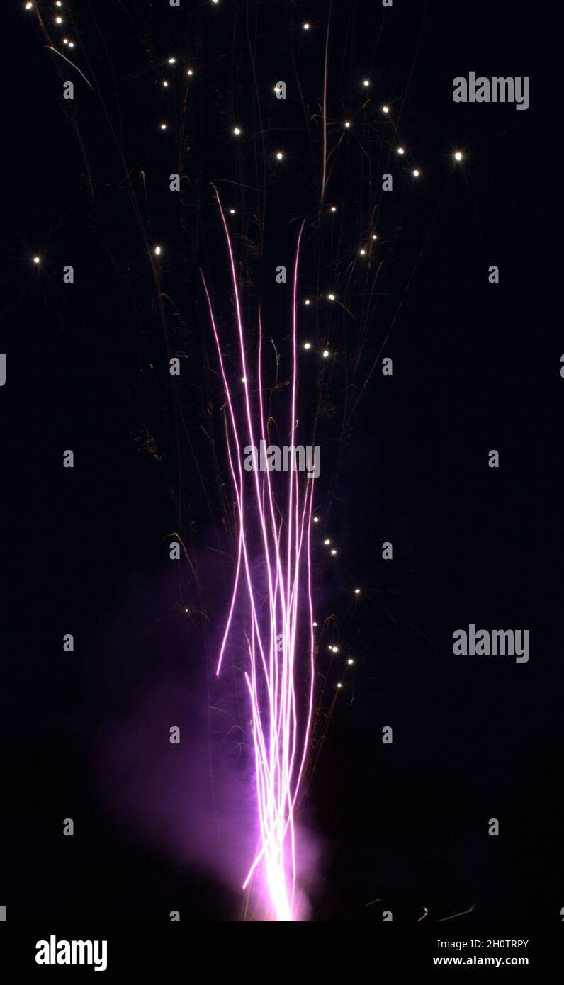 Vertical shot of fireworks on dark night background Stock Photo - Alamy