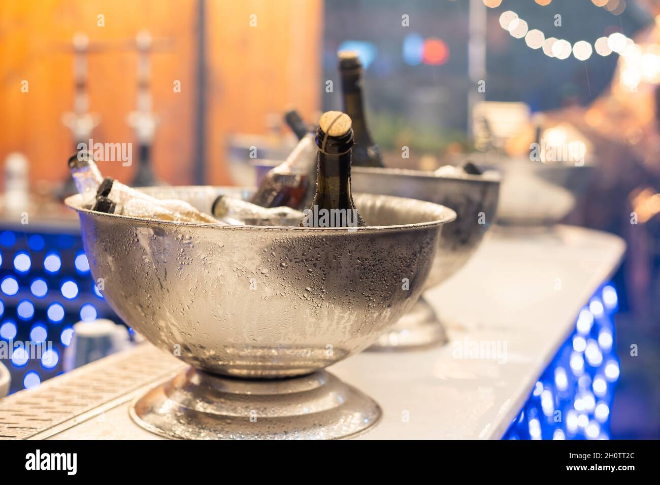 Wine bottles set in bucket, alcohol cooling Stock Photo - Alamy