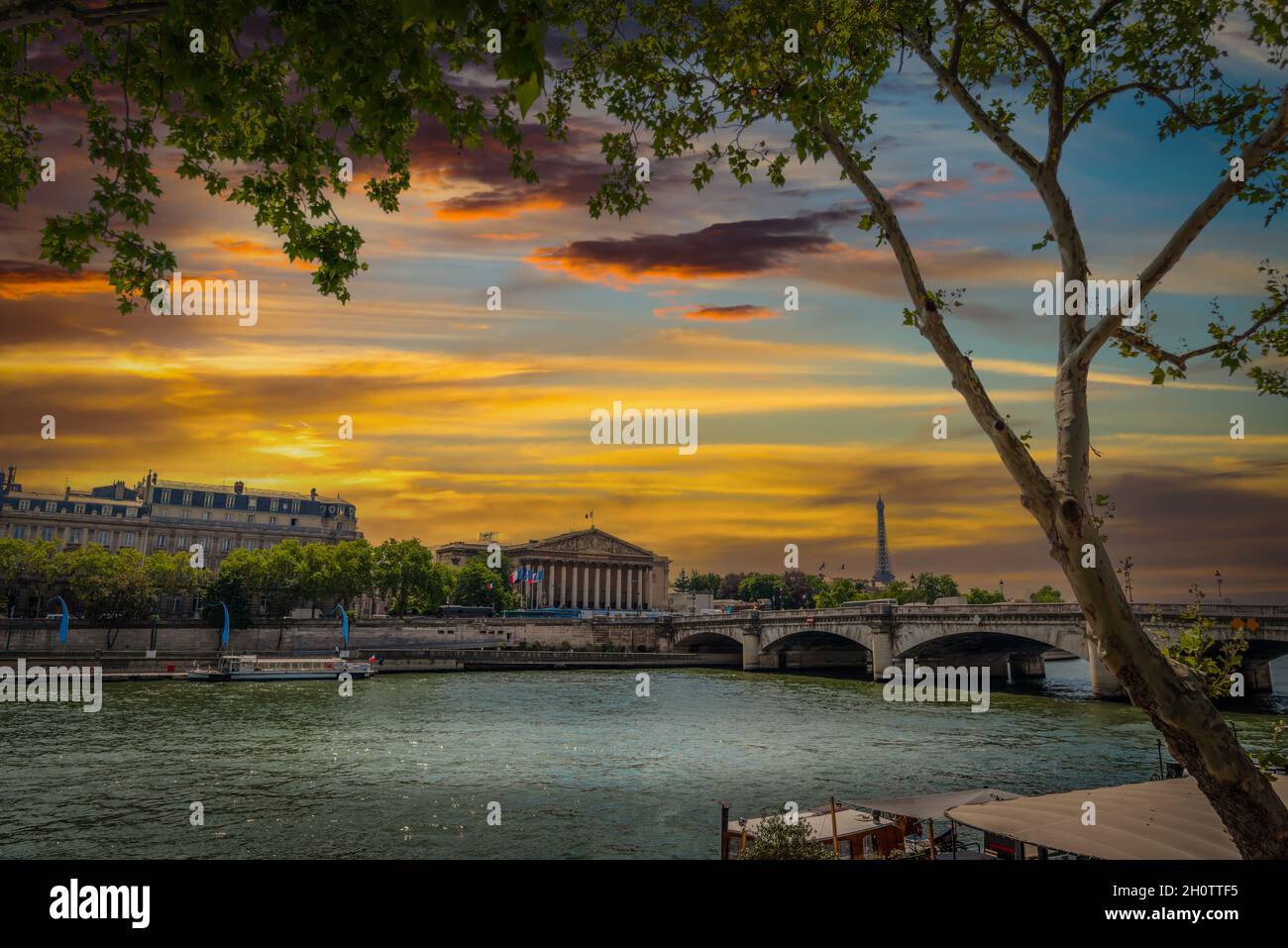 Colorful sky over Seine river in Paris at sunset, France Stock Photo ...