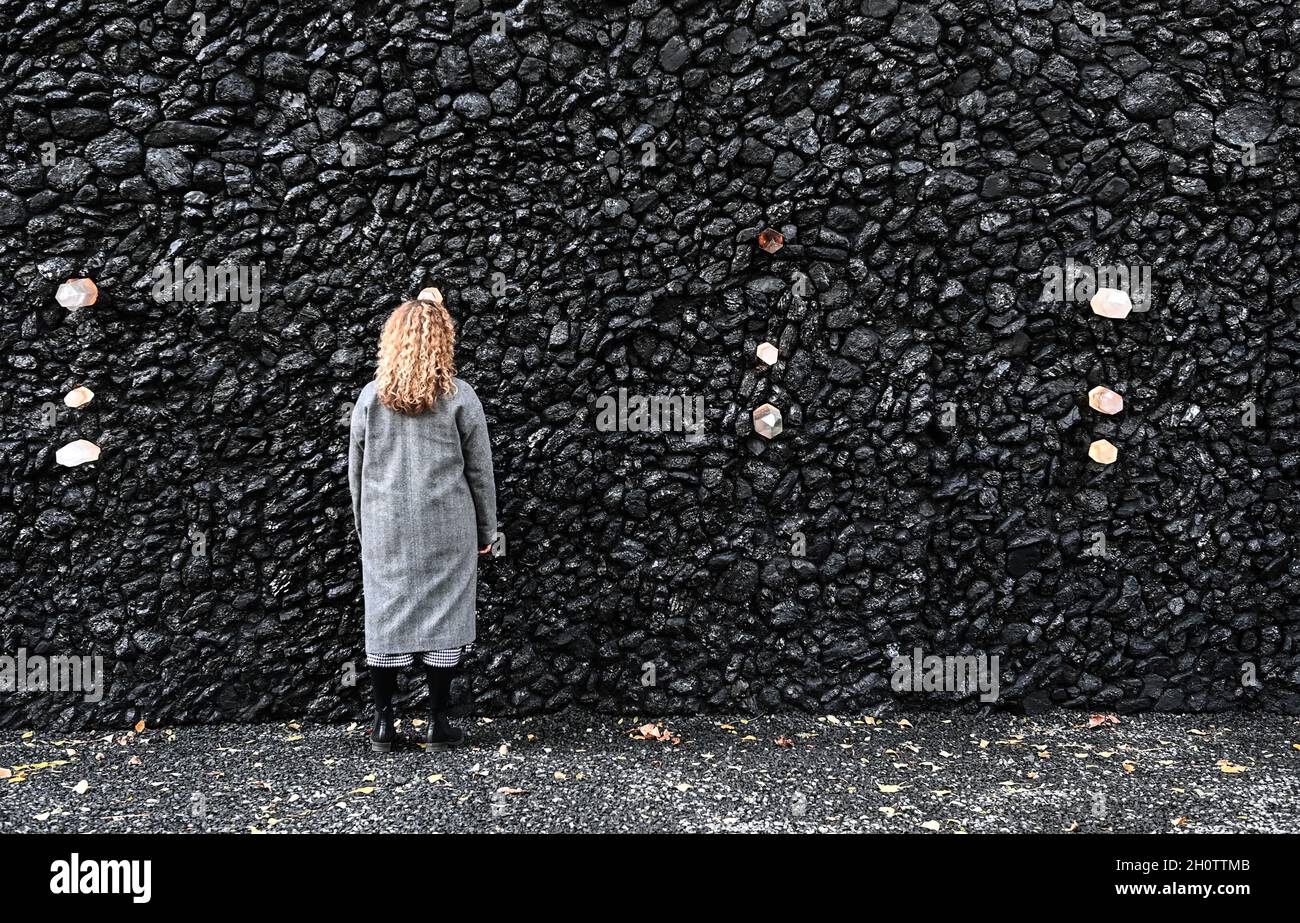 06 October 2021, Ukraine, Kiew: A woman stands at the "Crystal Wall of ...