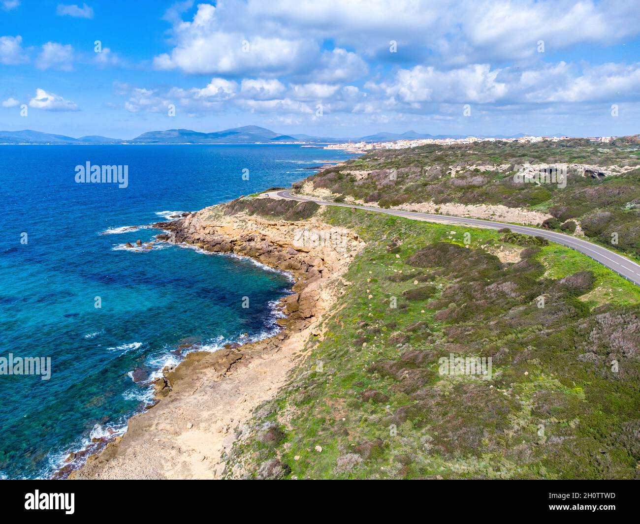 Aerial view of Alghero southern coast under a cloudy sky. Sardinia ...