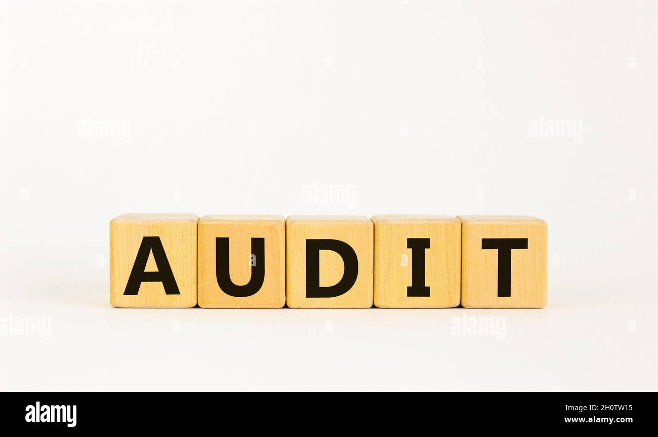 Audit symbol. The concept word 'audit' on wooden cubes. Beautiful white ...