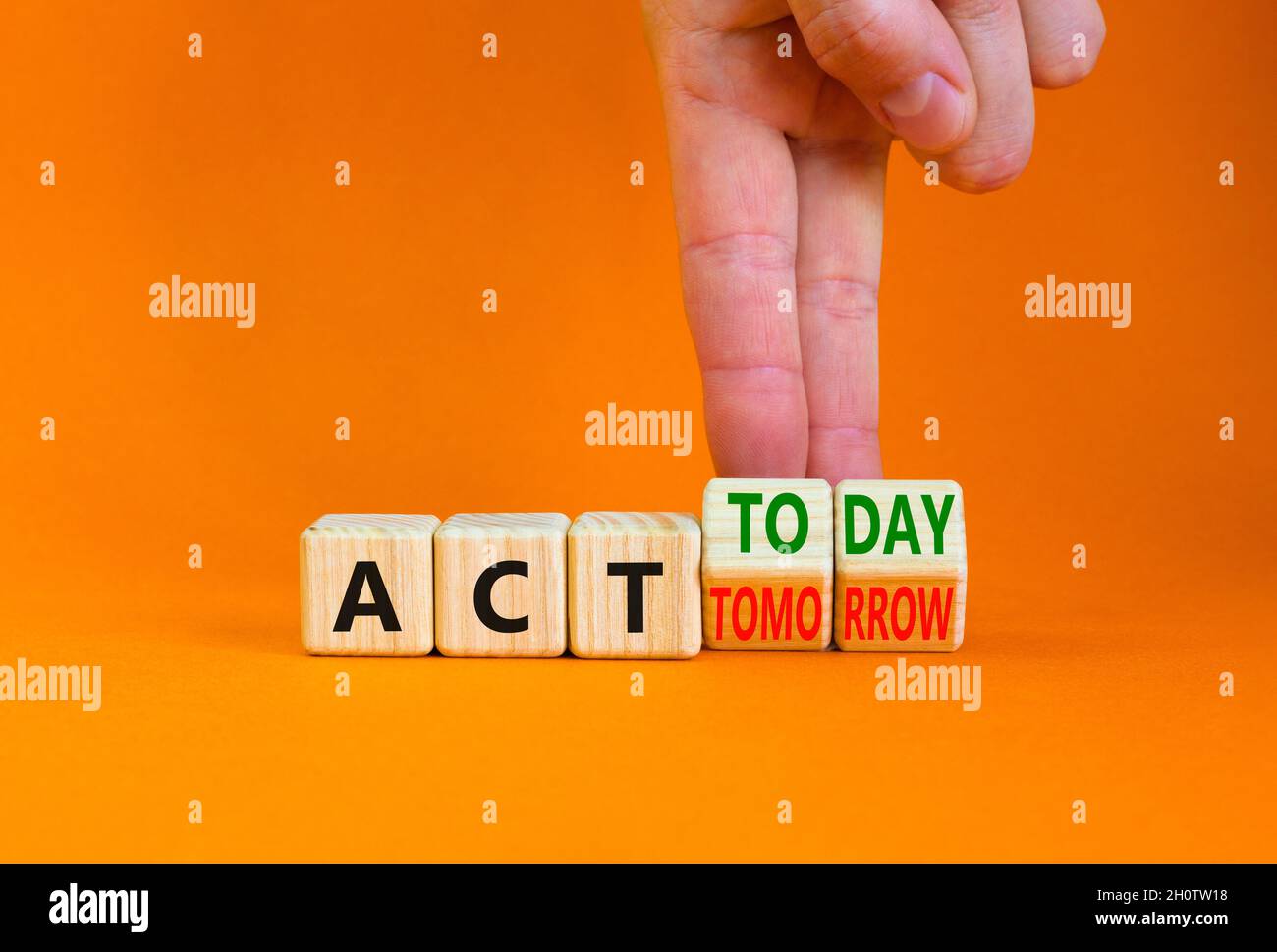 Act today not tomorrow symbol. Businessman turns wooden cubes, changes ...