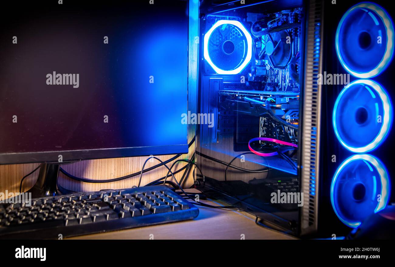 Pc case and monitor on a desk in the dark Stock Photo - Alamy