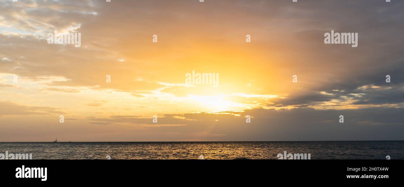 Boat sailing under a shining sun at sunset. Florida, USA Stock Photo ...