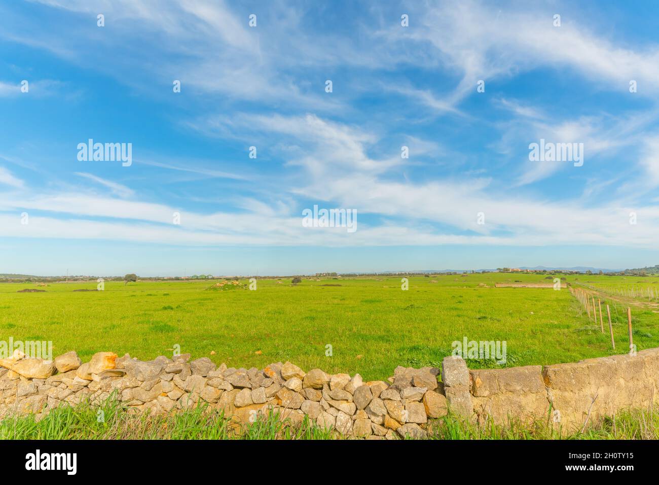 Dry stone wall in the Sardinian countryside under a blue sky, Italy ...